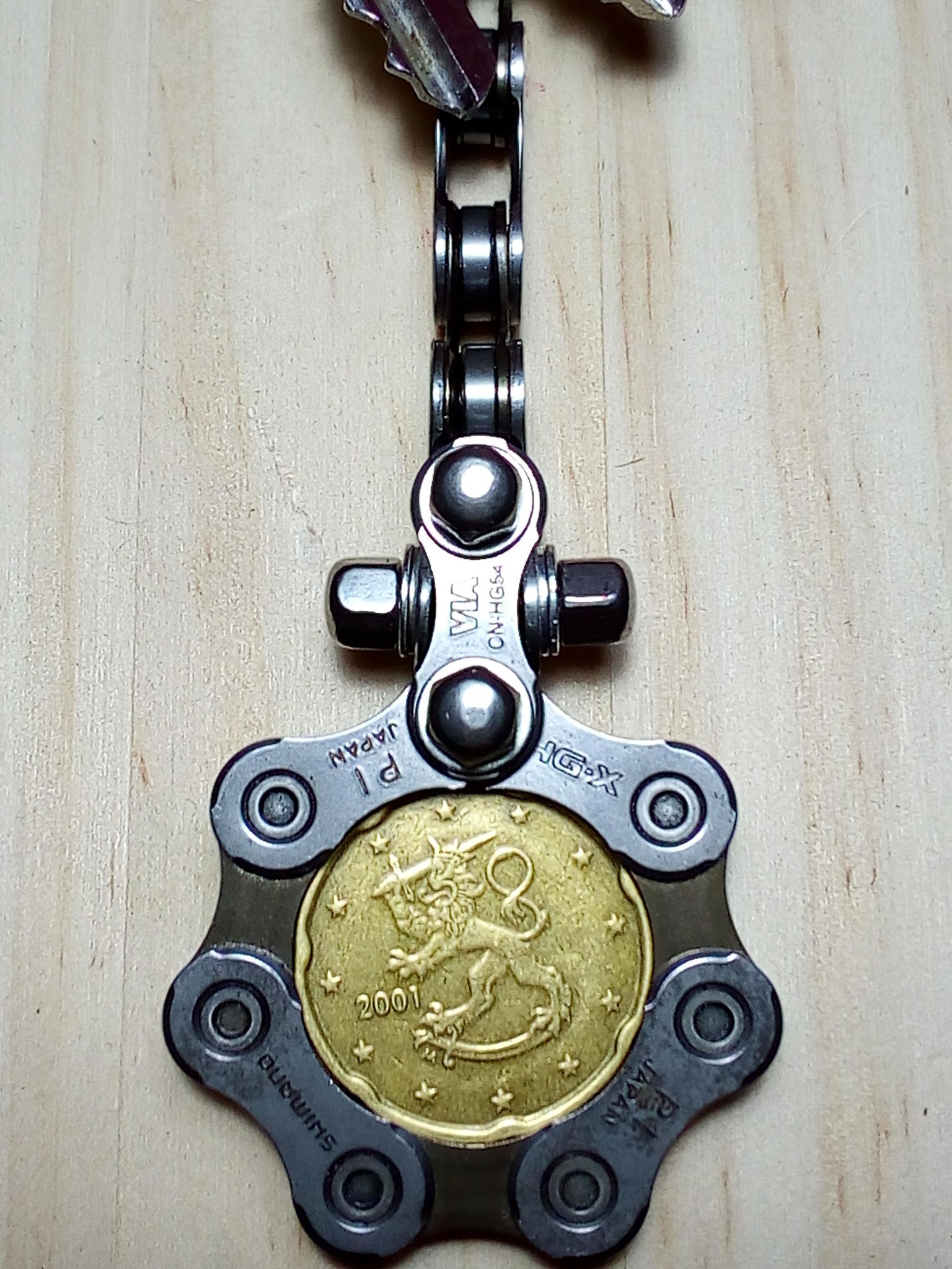 with coins - swisstrailbell® meets bicycle chain art