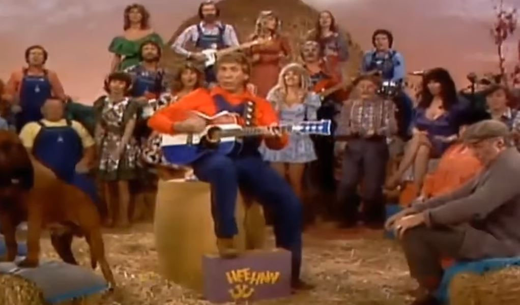 Buck Owens And The Whole Hee Haw Gang performs "Gonna Roll Out The Red ...