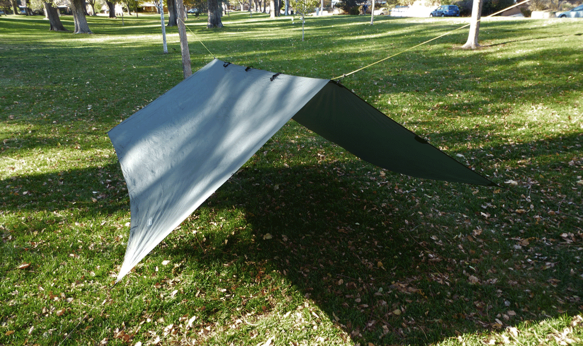 An open tarp shelter with the Dutchware continuous ridge line ...